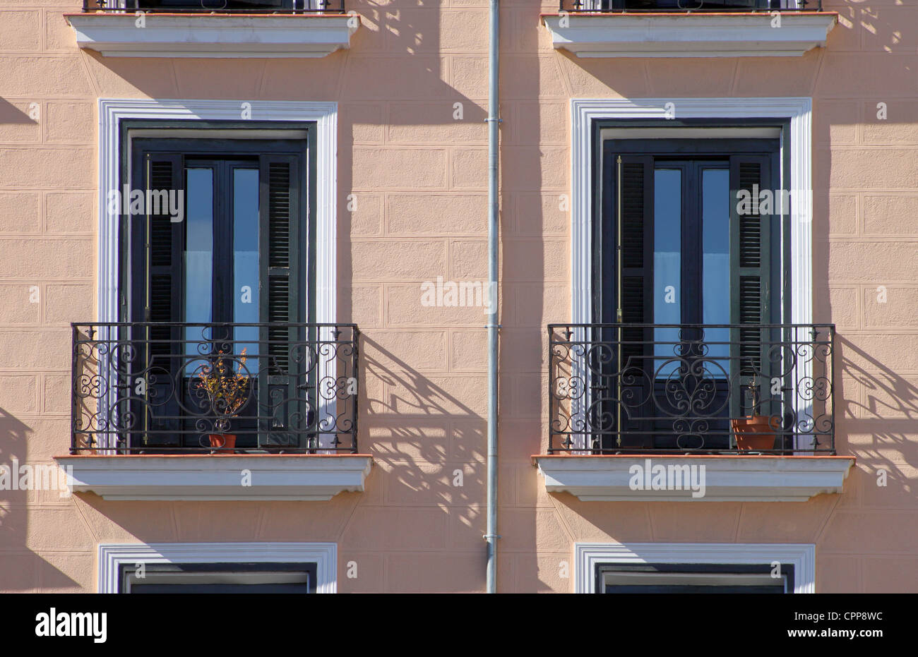 Pink facade Madrid residential building with balconies Stock Photo - Alamy