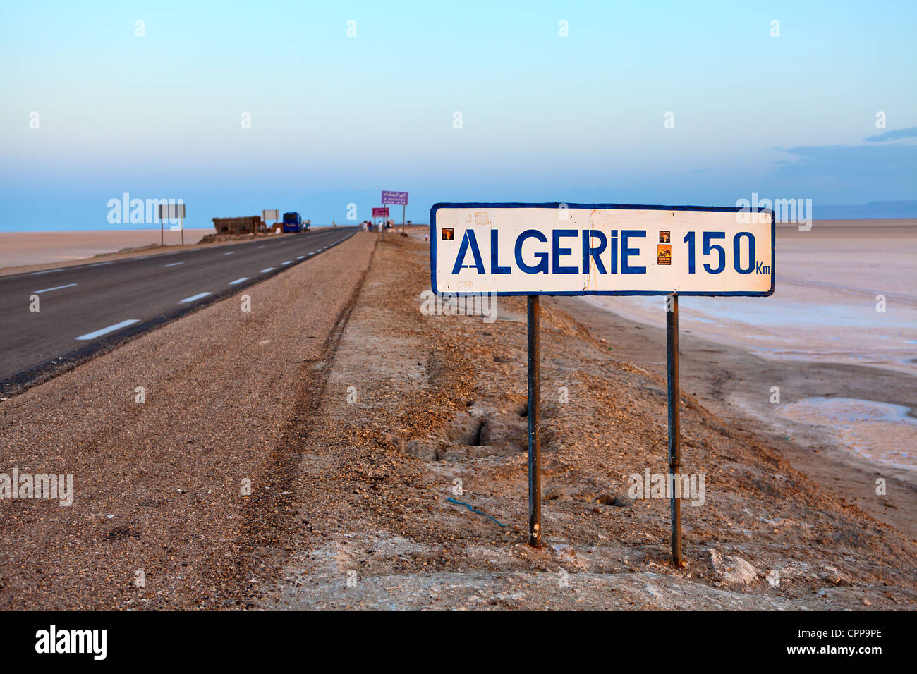 Road to the Algeria across a large endorheic salt lake Chott el Djerid ...