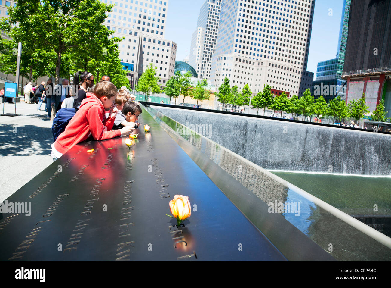 9/11 memorial at ground zero, waterfalls with names inscribed around ...