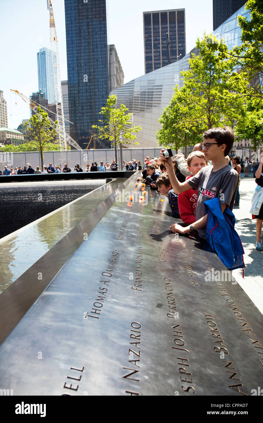 9/11 memorial at ground zero, waterfalls with names inscribed around ...