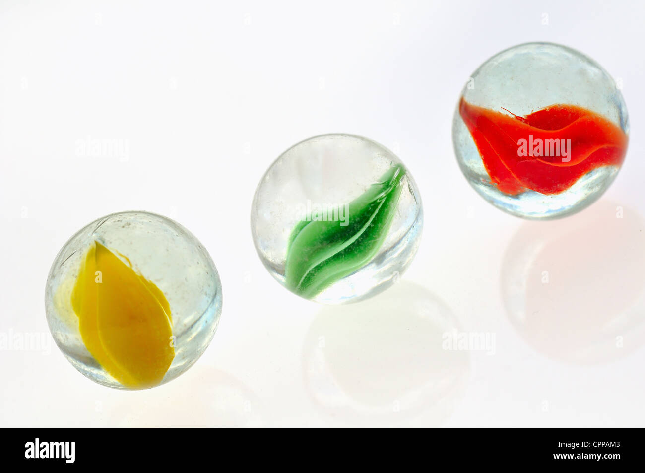 Three marbles on white background Stock Photo - Alamy