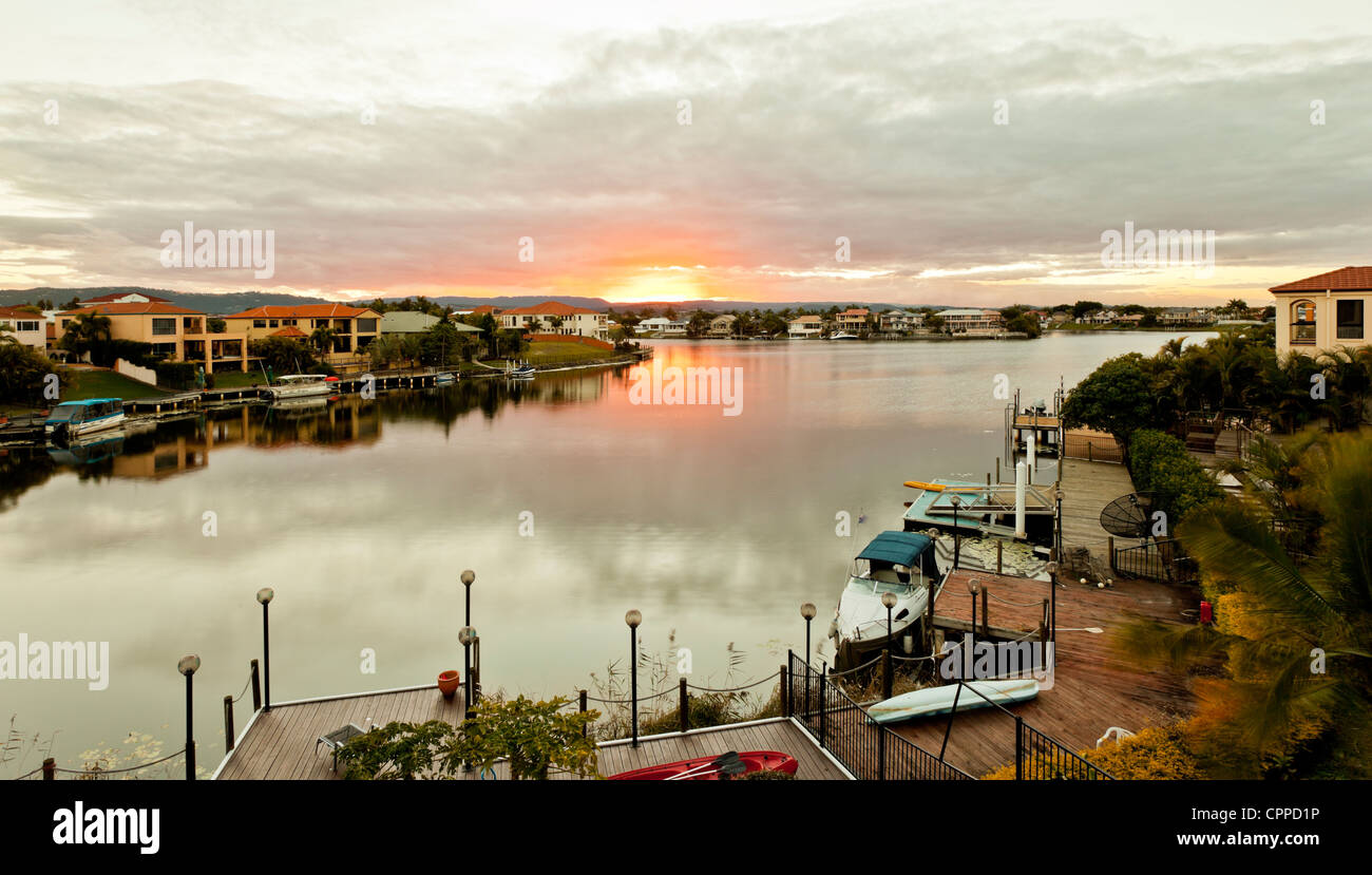 Sunset over luxury waterfront houses Stock Photo - Alamy