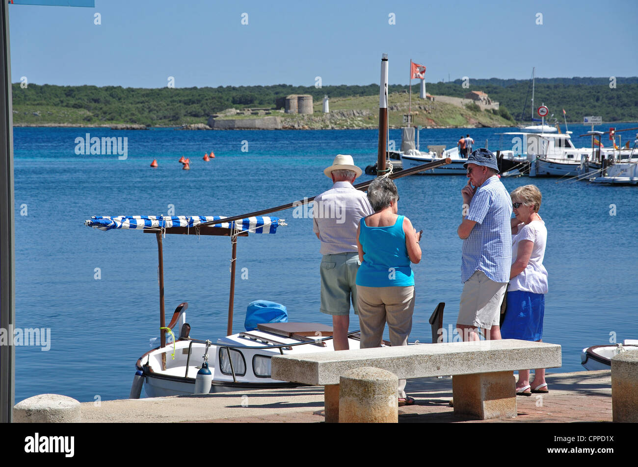 Older group on marina promenade, Fornells, Menorca, Balearic Islands ...