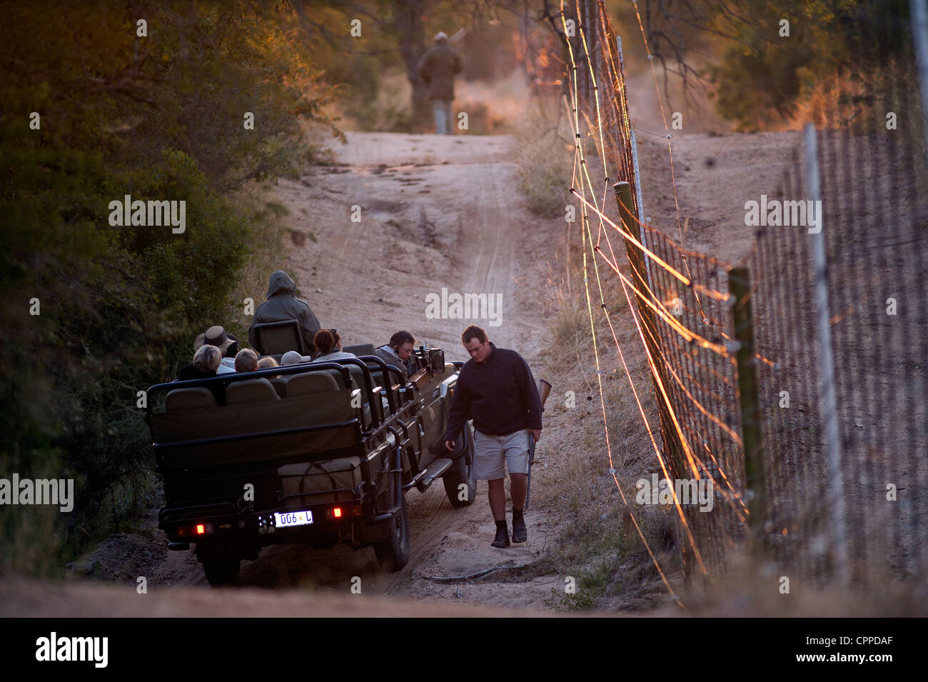 Ranger and Tracker search for animal tracks with tourists in vehicle in ...