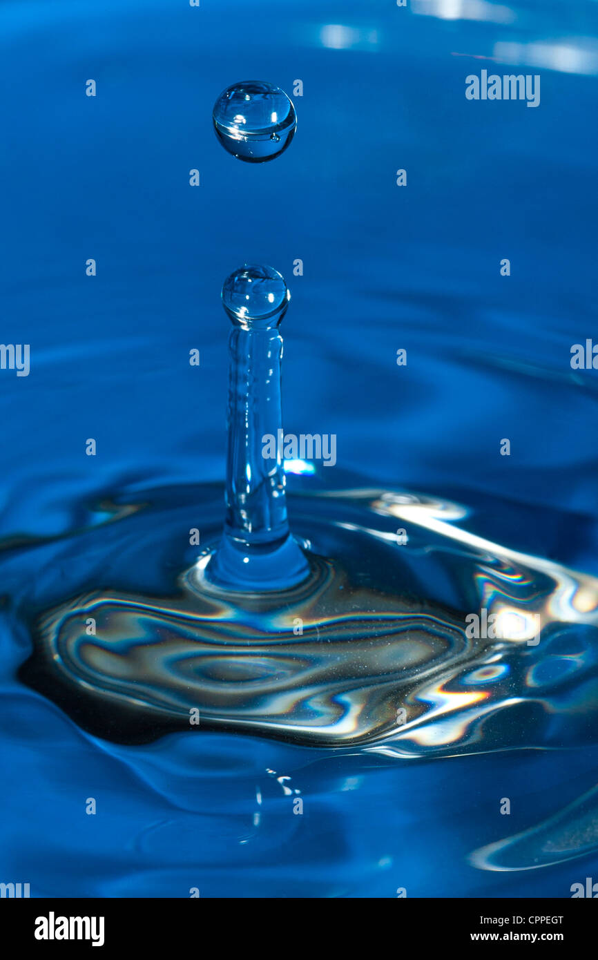 A water drop falling into still water Stock Photo - Alamy