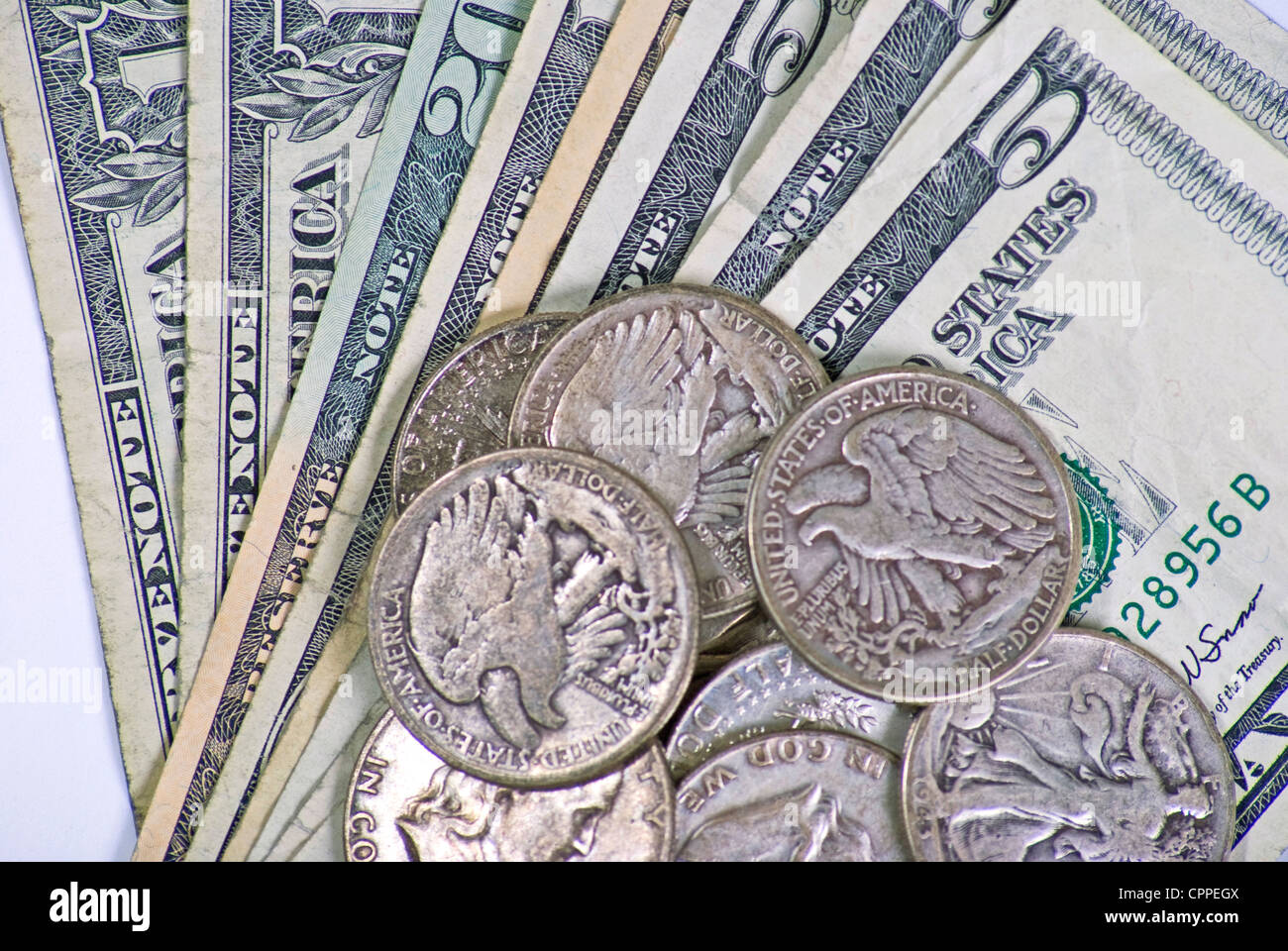 Small pile of small American bills and old silver half dollars Stock ...