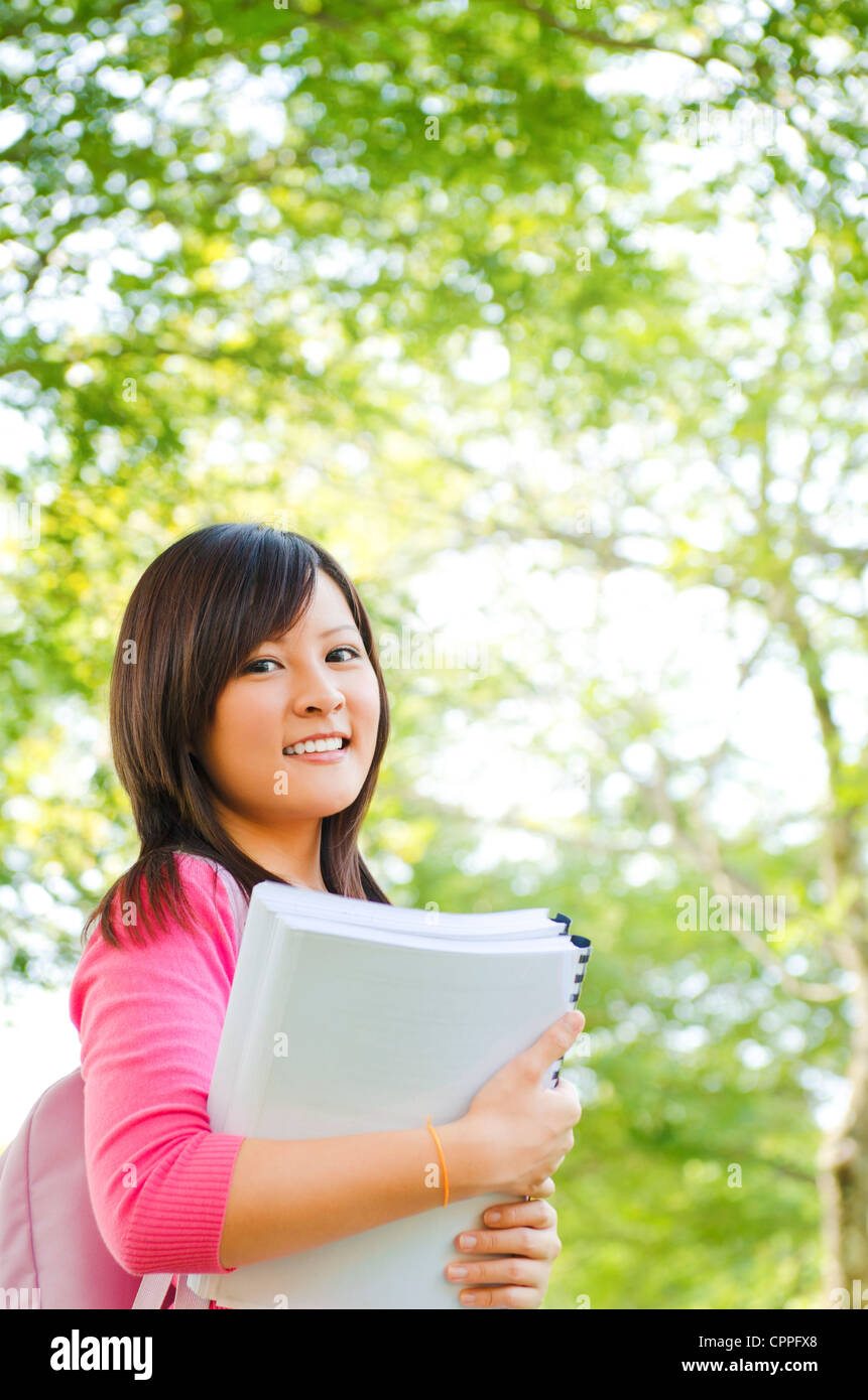 College student standing outside campus, green park Stock Photo - Alamy