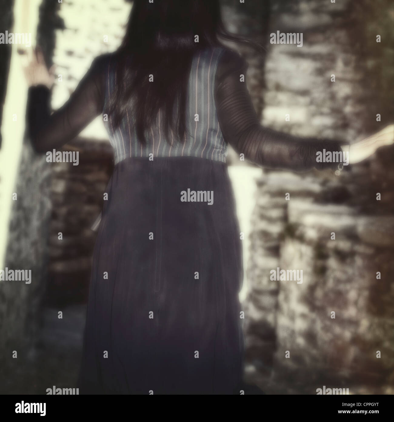 young woman is trying to escape and runs into a narrow alley Stock ...