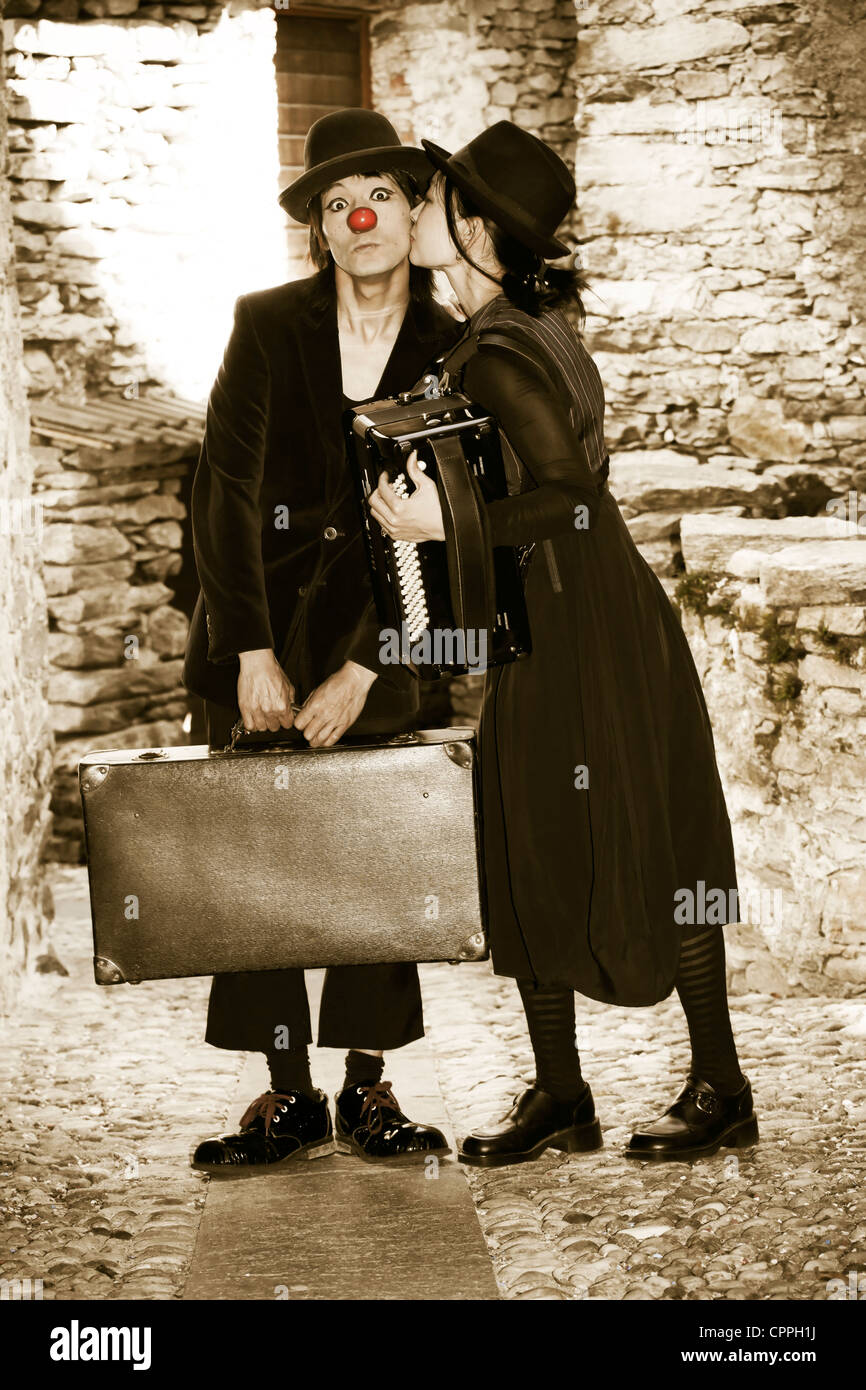 a couple of clowns - the woman kisses the man Stock Photo - Alamy