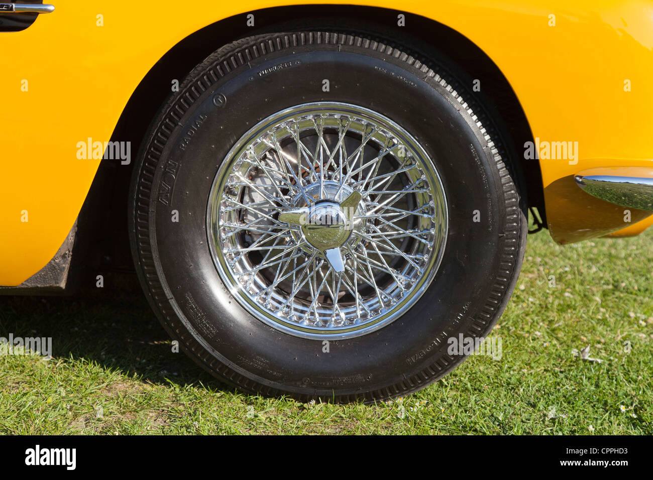Yellow sports car chrome spoked wheel and tyre Stock Photo - Alamy