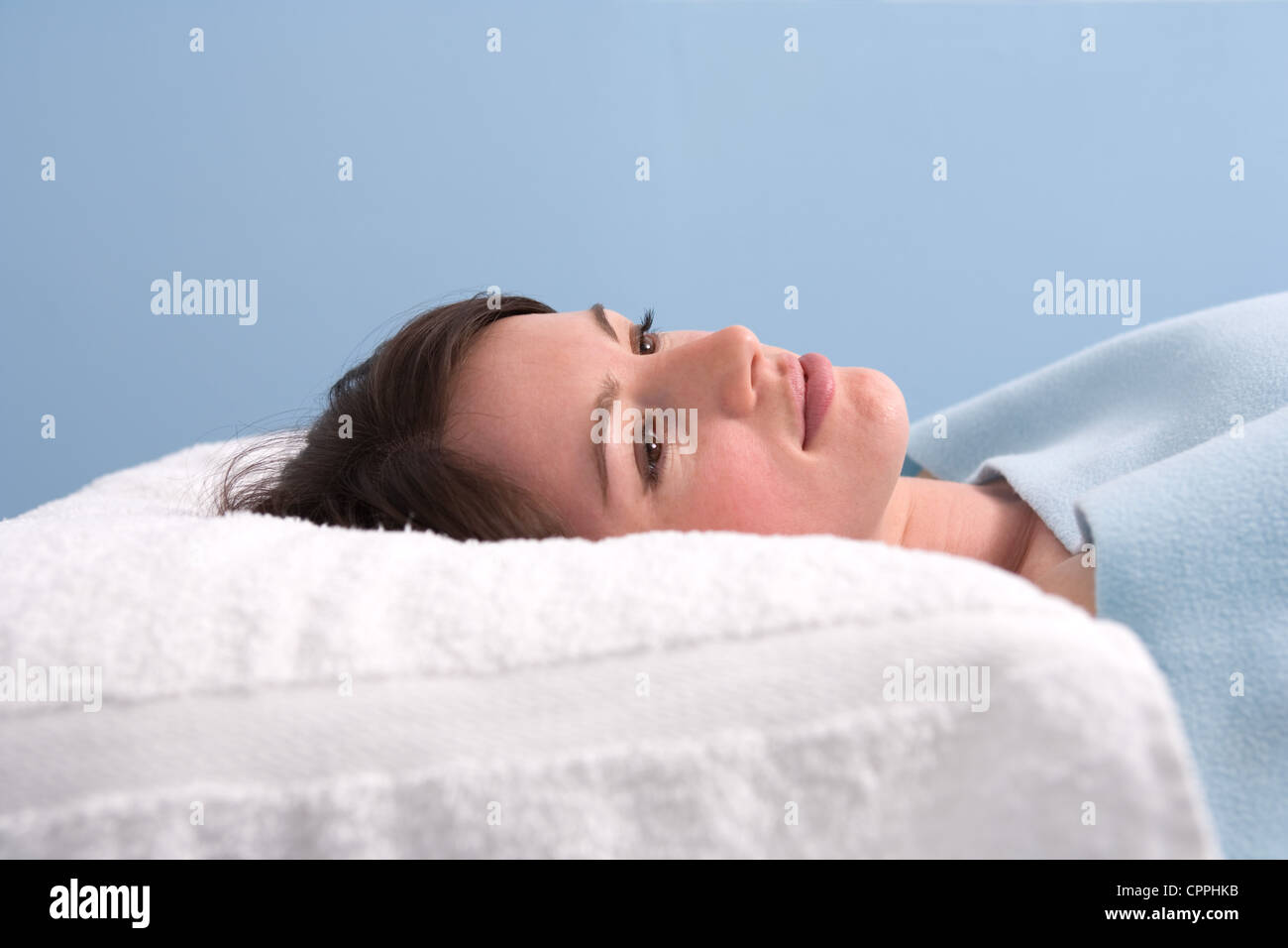Portrait of woman lying on therapy bed Stock Photo - Alamy