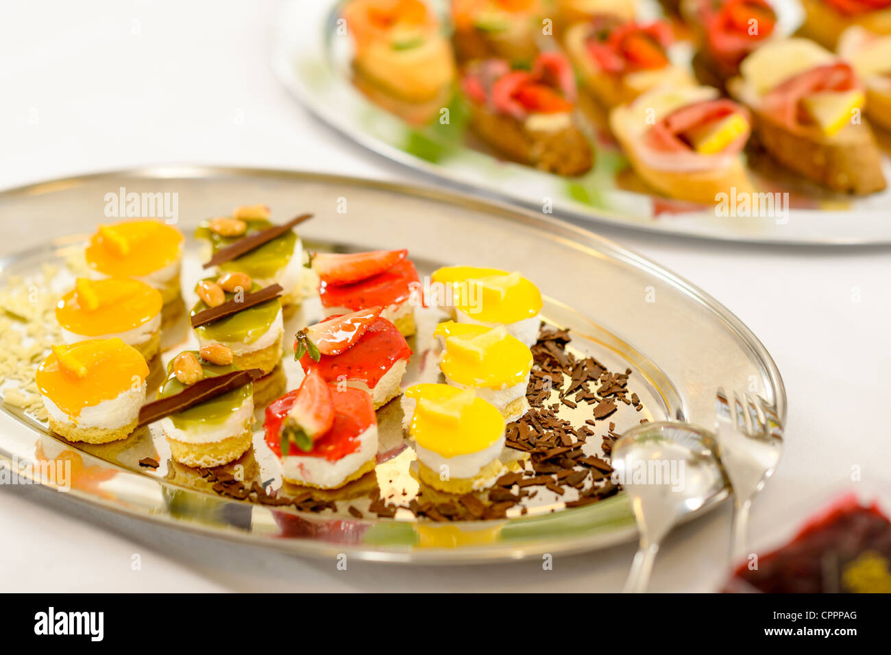 Appetizers mini desserts on catering buffet white tablecloth Stock ...