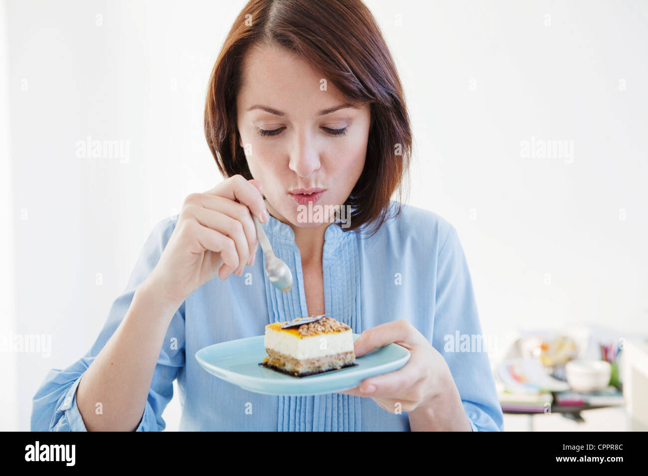 WOMAN EATING SWEETS Stock Photo - Alamy