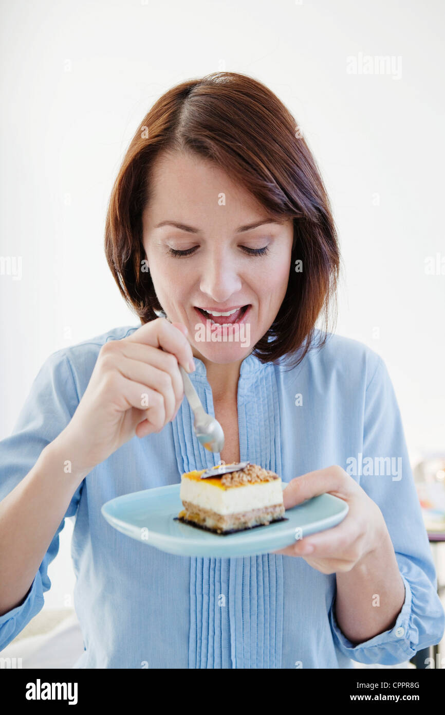 WOMAN EATING SWEETS Stock Photo - Alamy