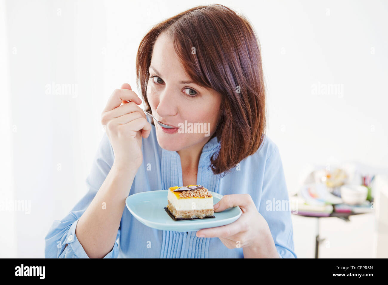 WOMAN EATING SWEETS Stock Photo - Alamy