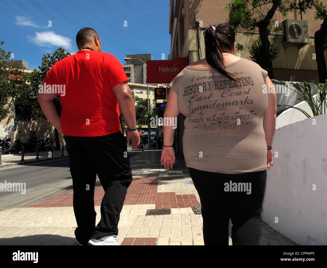 Over weight people walking in street Stock Photo - Alamy