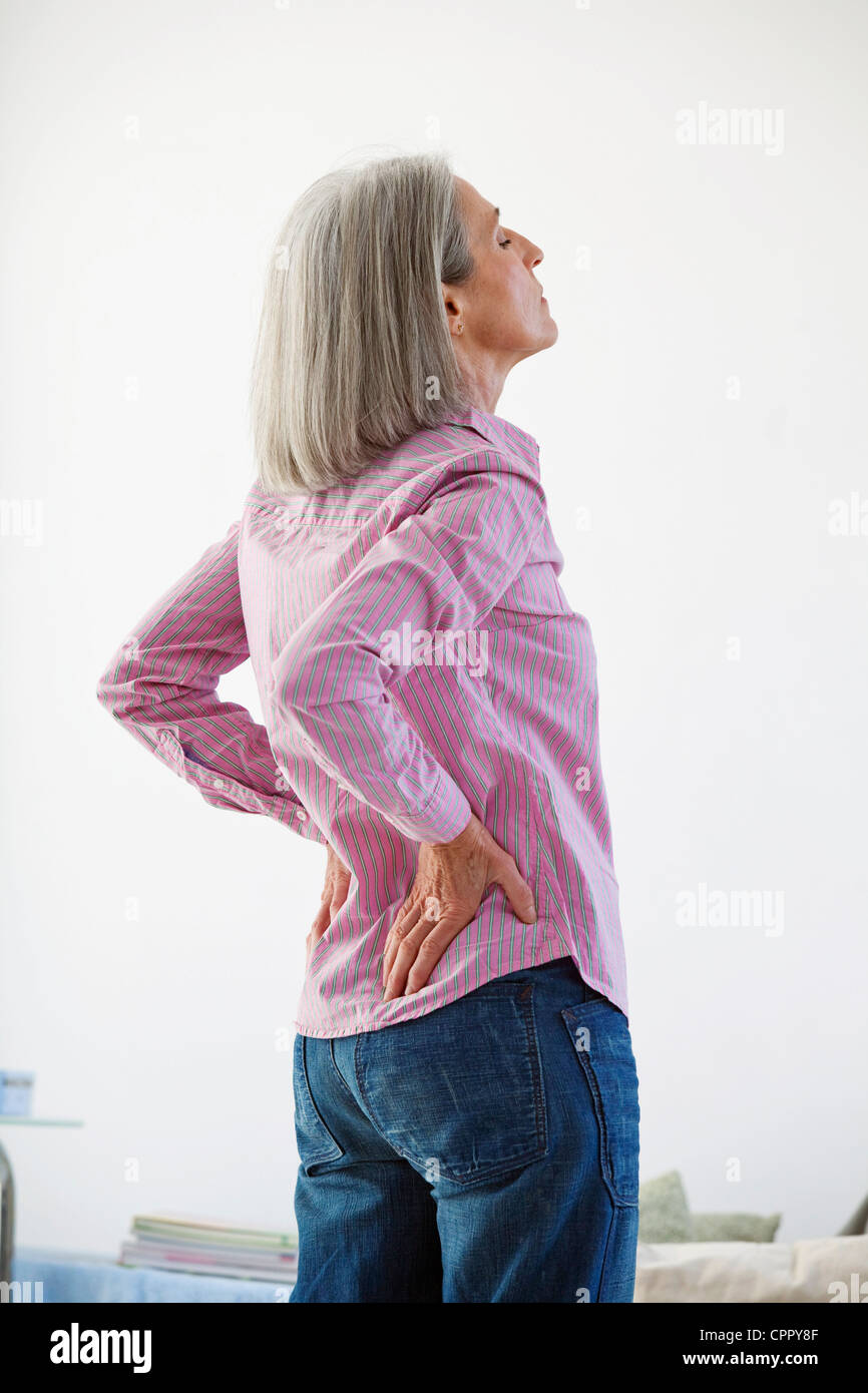 LOWER BACK PAIN IN ELDERLY PERS Stock Photo - Alamy