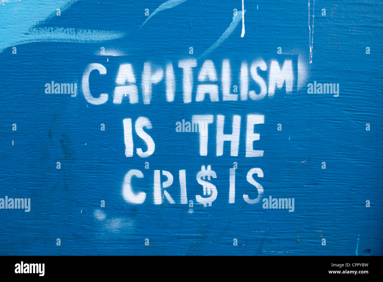 Capitalism is the Crisis sign stencilled political notice with dollar ...