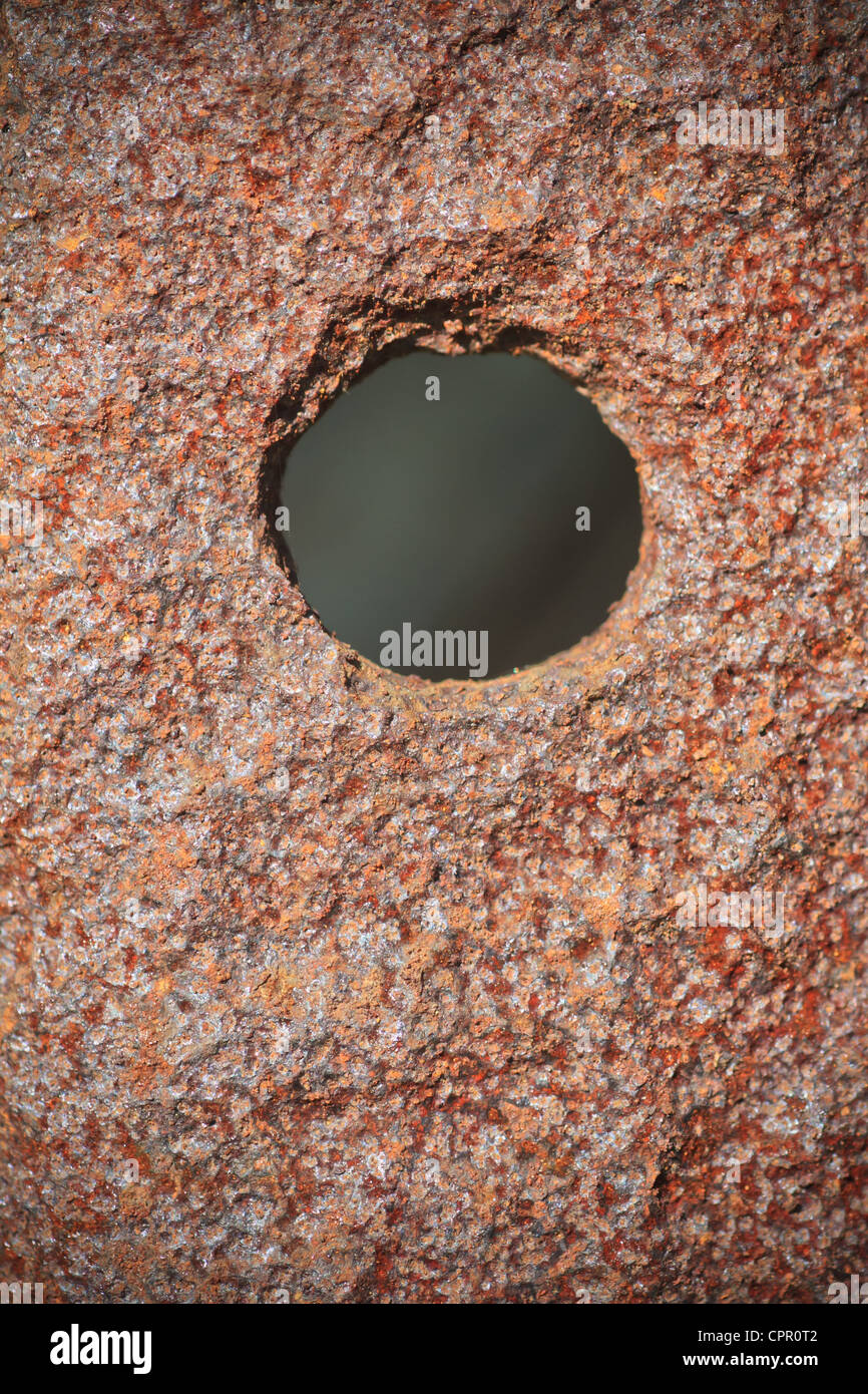 Hole in a rusty metal Stock Photo - Alamy