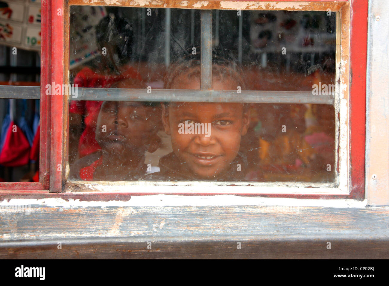 A child in school looks out of the dusty window Stock Photo - Alamy
