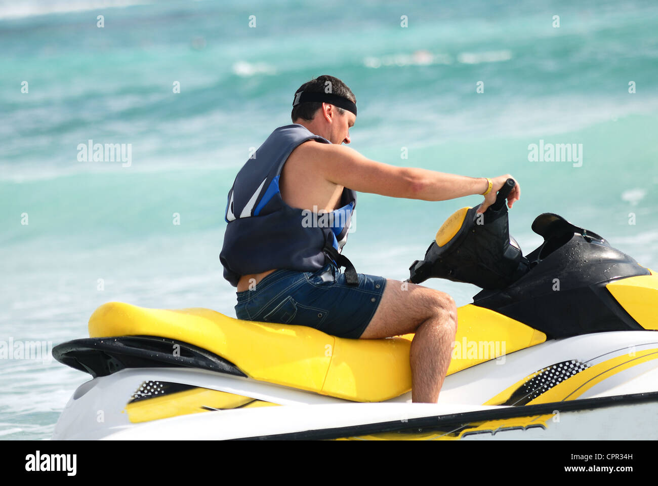 Man on Wave Runner turns fast on the water Stock Photo - Alamy