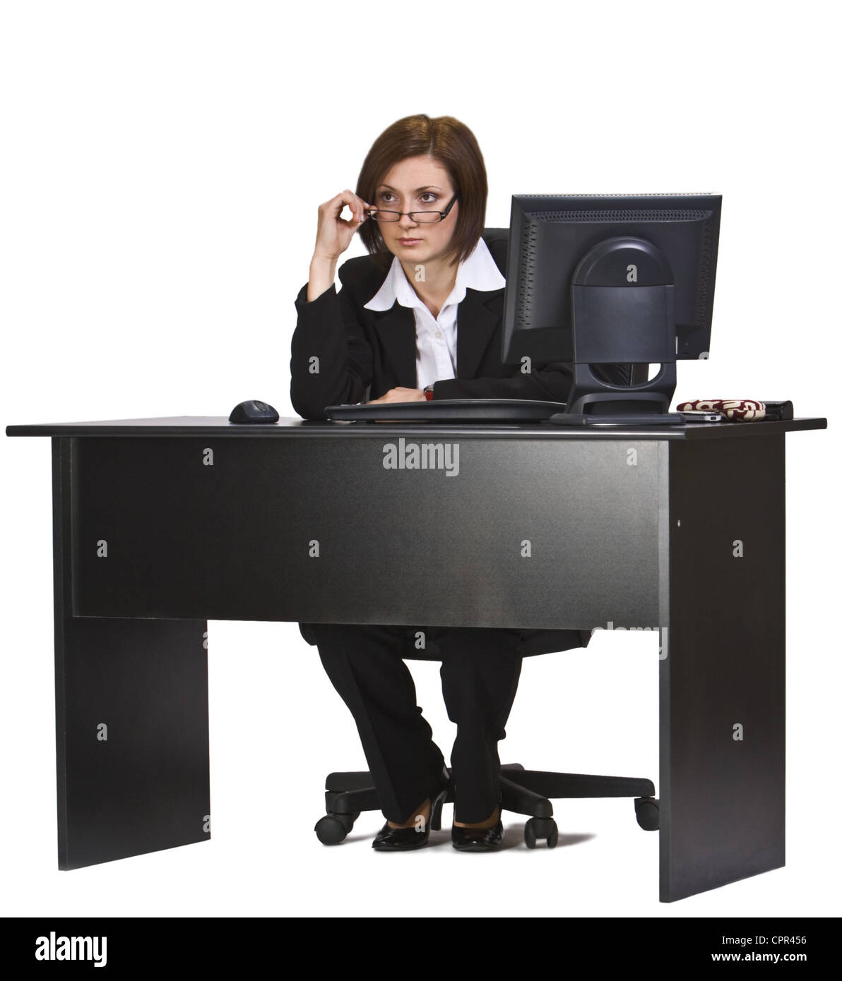 Businesswoman at her office desk looking over the glasses Stock Photo ...