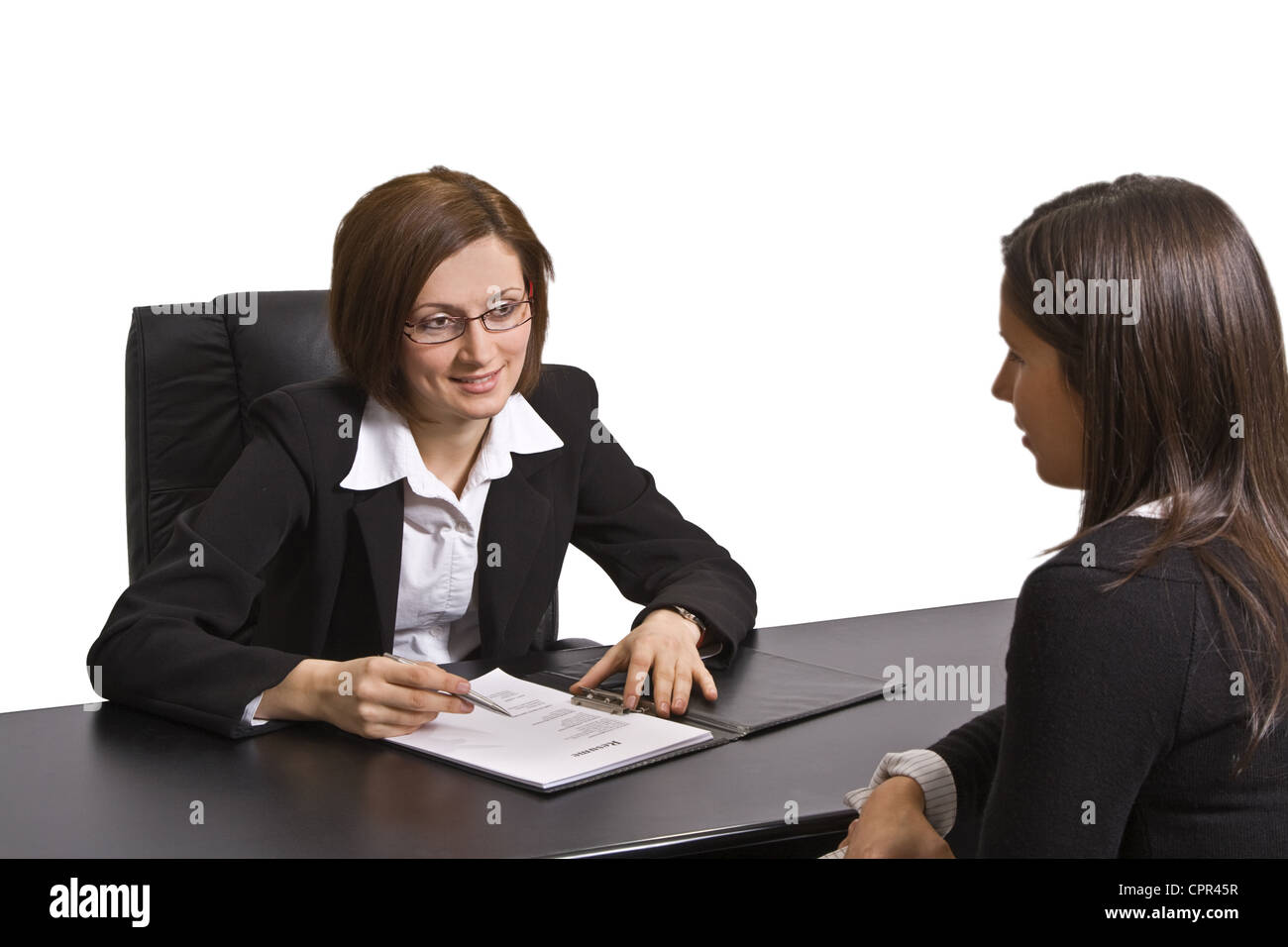 Two businesswomen at an interview in an office.The documents on the ...