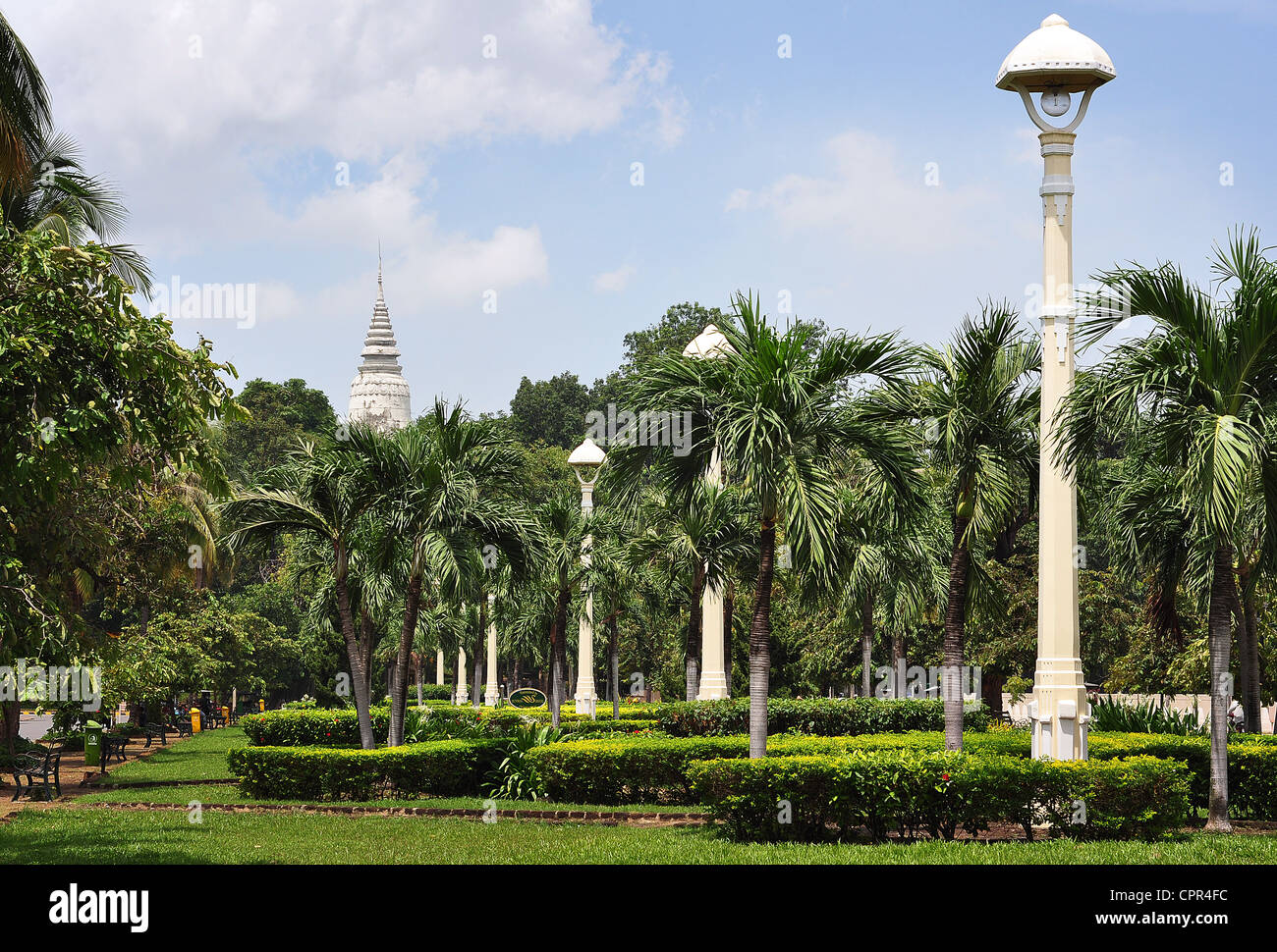 Phnom Penh park with a view of the top of Wat Phnom Stock Photo - Alamy