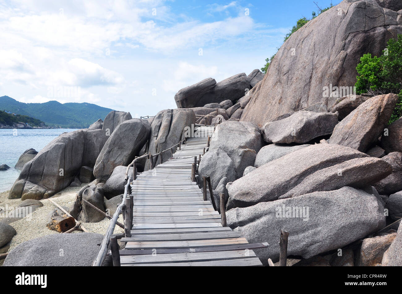 Island paradise wooden walkway set amongst beach stones Stock Photo - Alamy