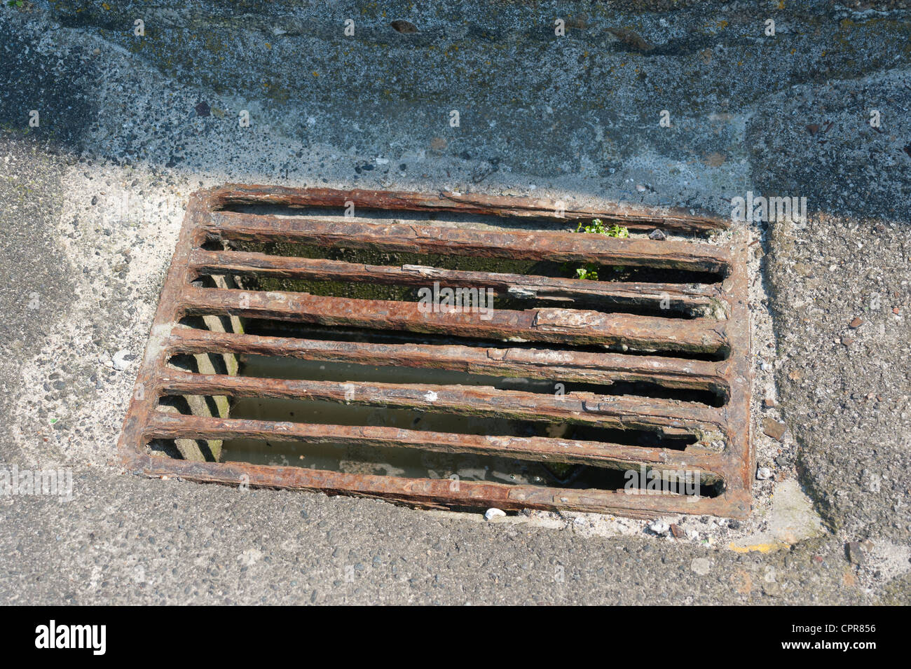 Rusty metal drain grid Stock Photo - Alamy