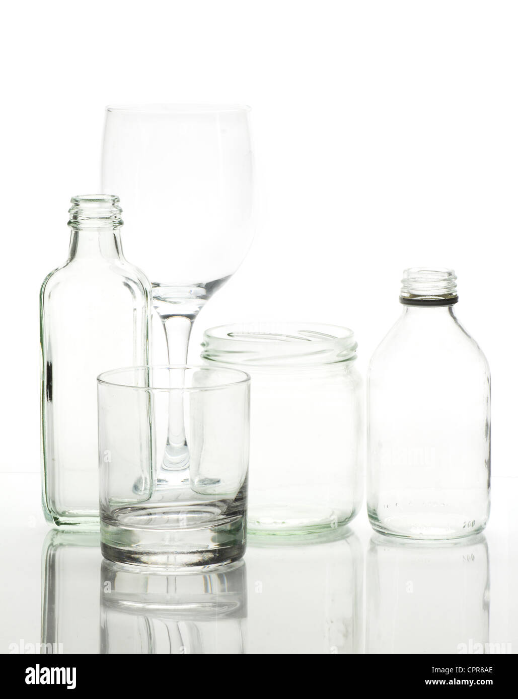 selection of glass kitchen items on white background with gradual grey ...