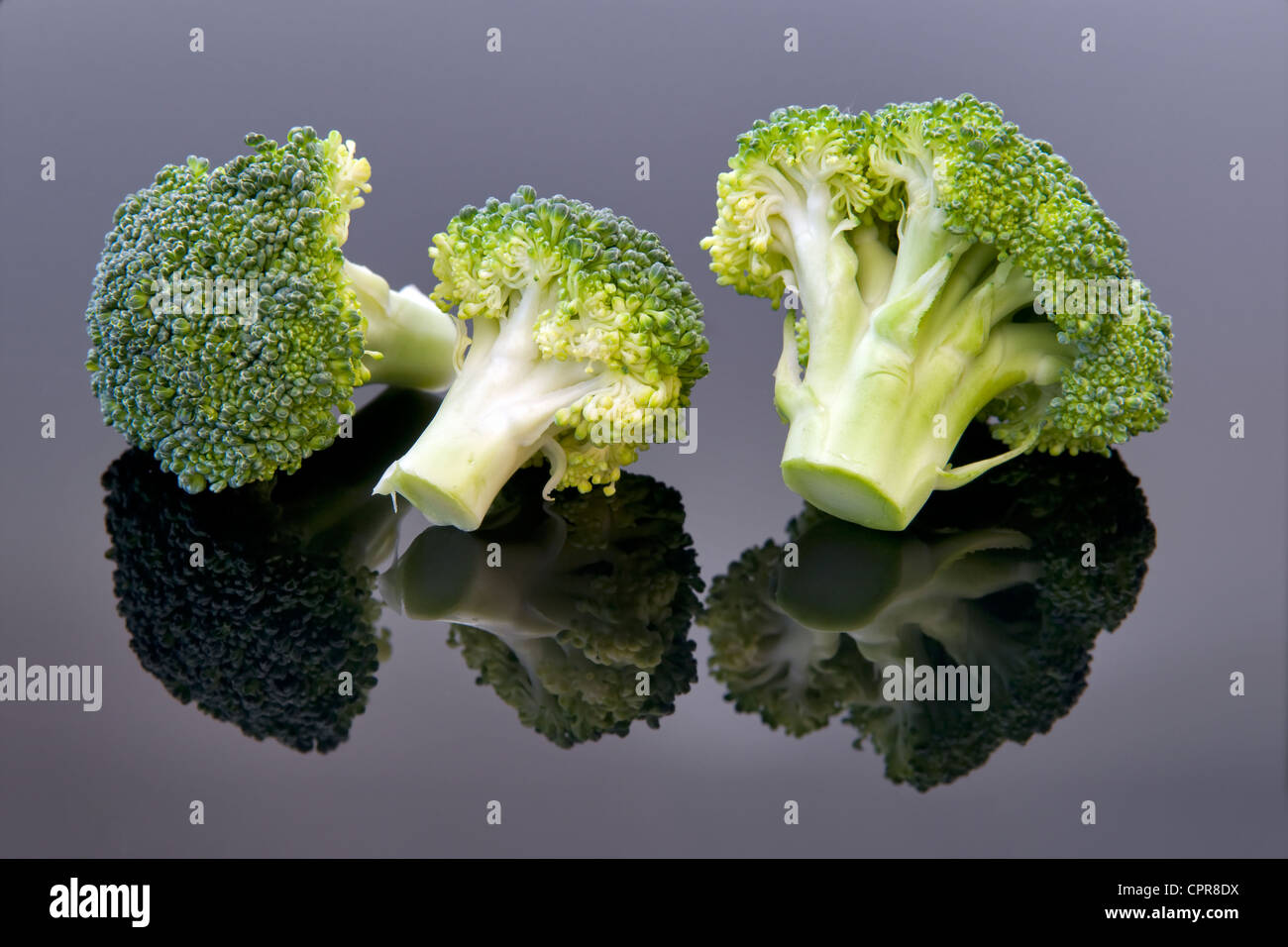 Studio image of fresh uncooked broccoli with reflection on black ...