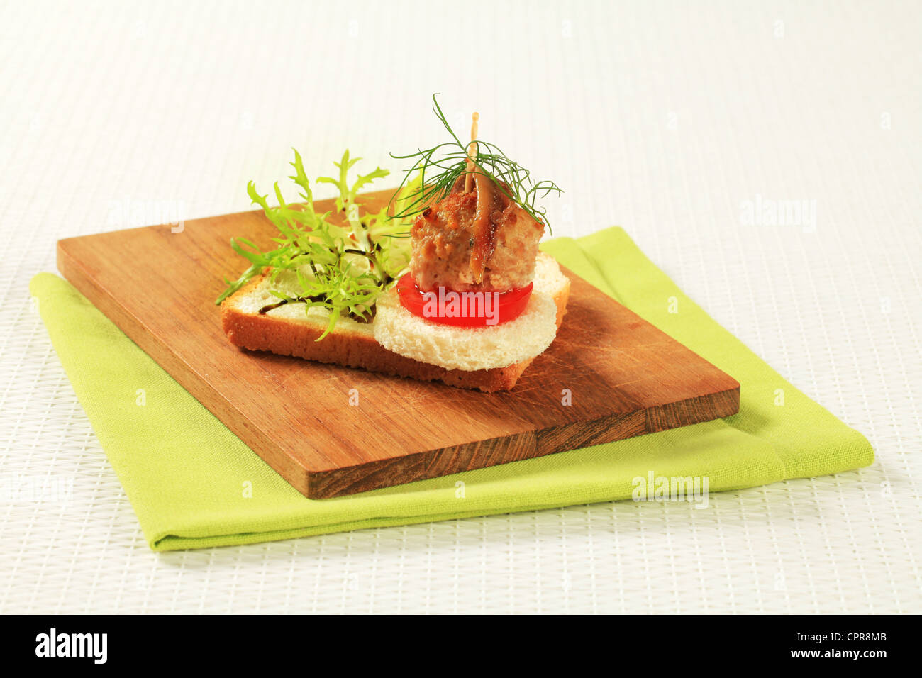 Meatball canape on a cocktail stick and fresh endive Stock Photo - Alamy