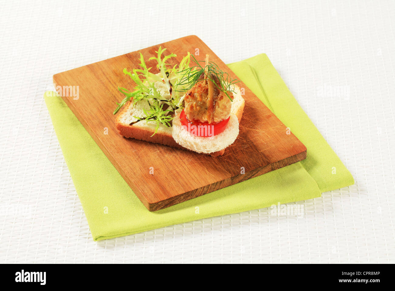 Meatball canape on a cocktail stick and fresh endive Stock Photo - Alamy