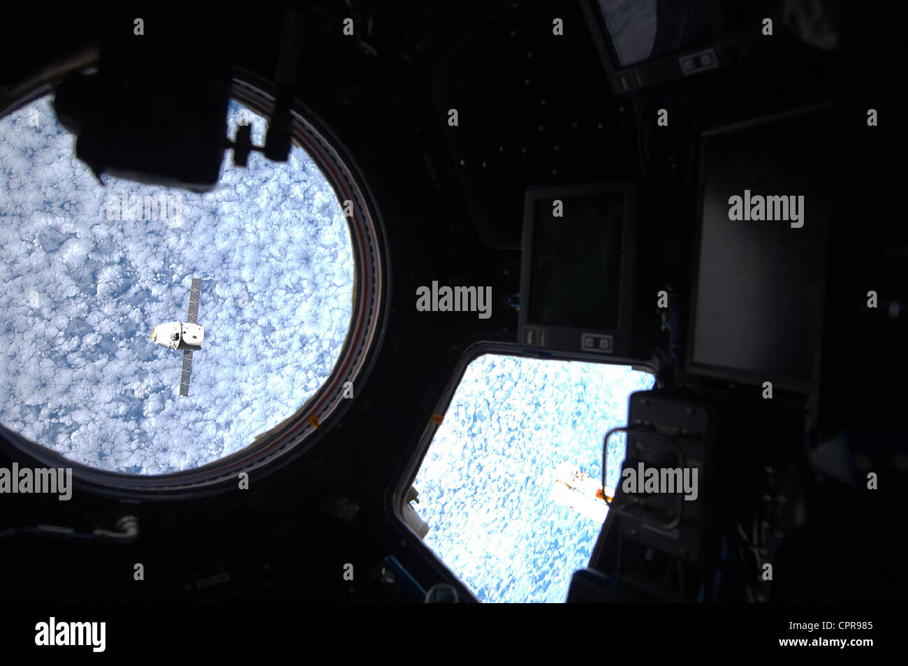 As seen through windows of the ISS the SpaceX Dragon commercial cargo ...