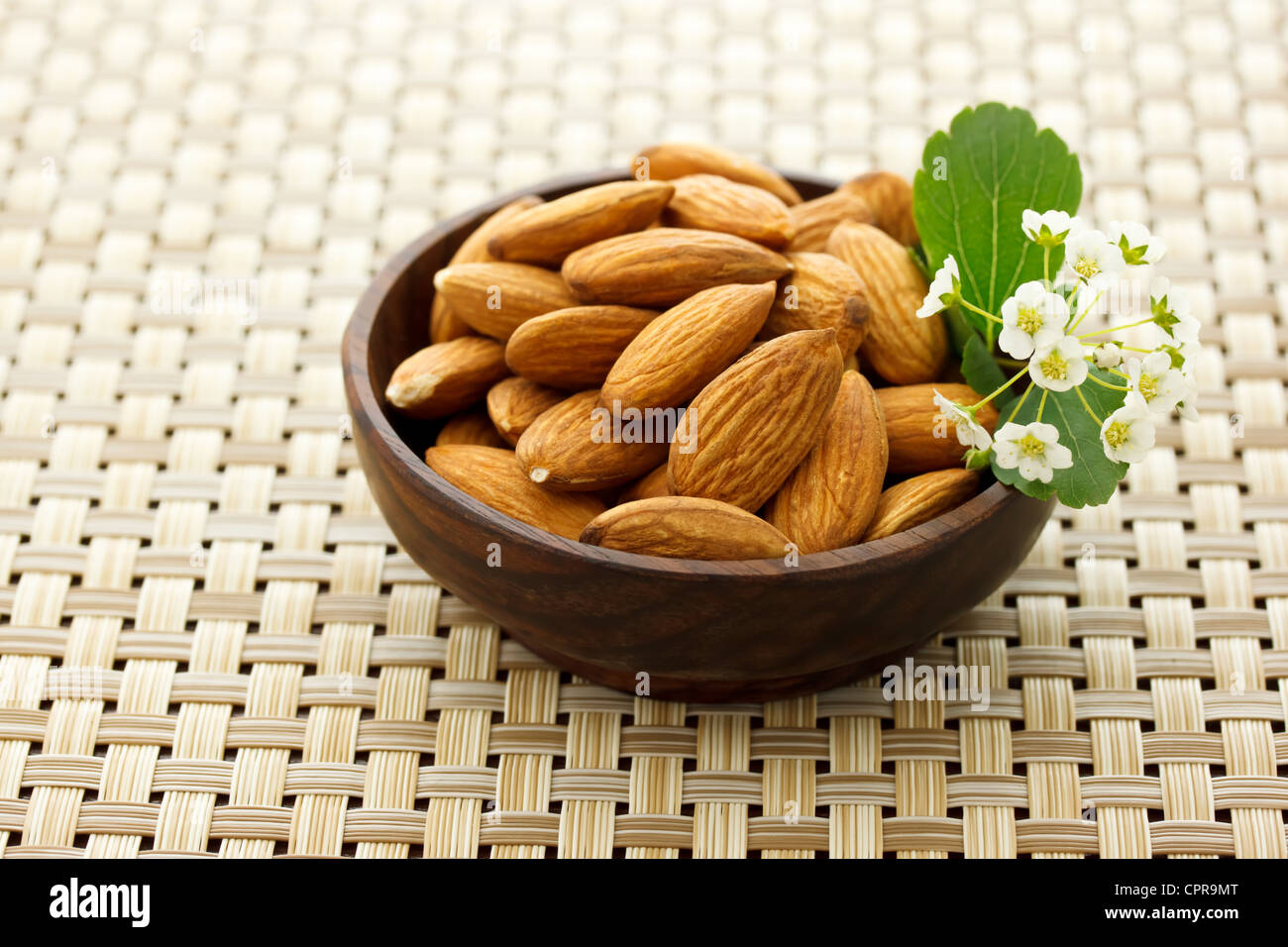 Almonds in wooden bowl Stock Photo - Alamy
