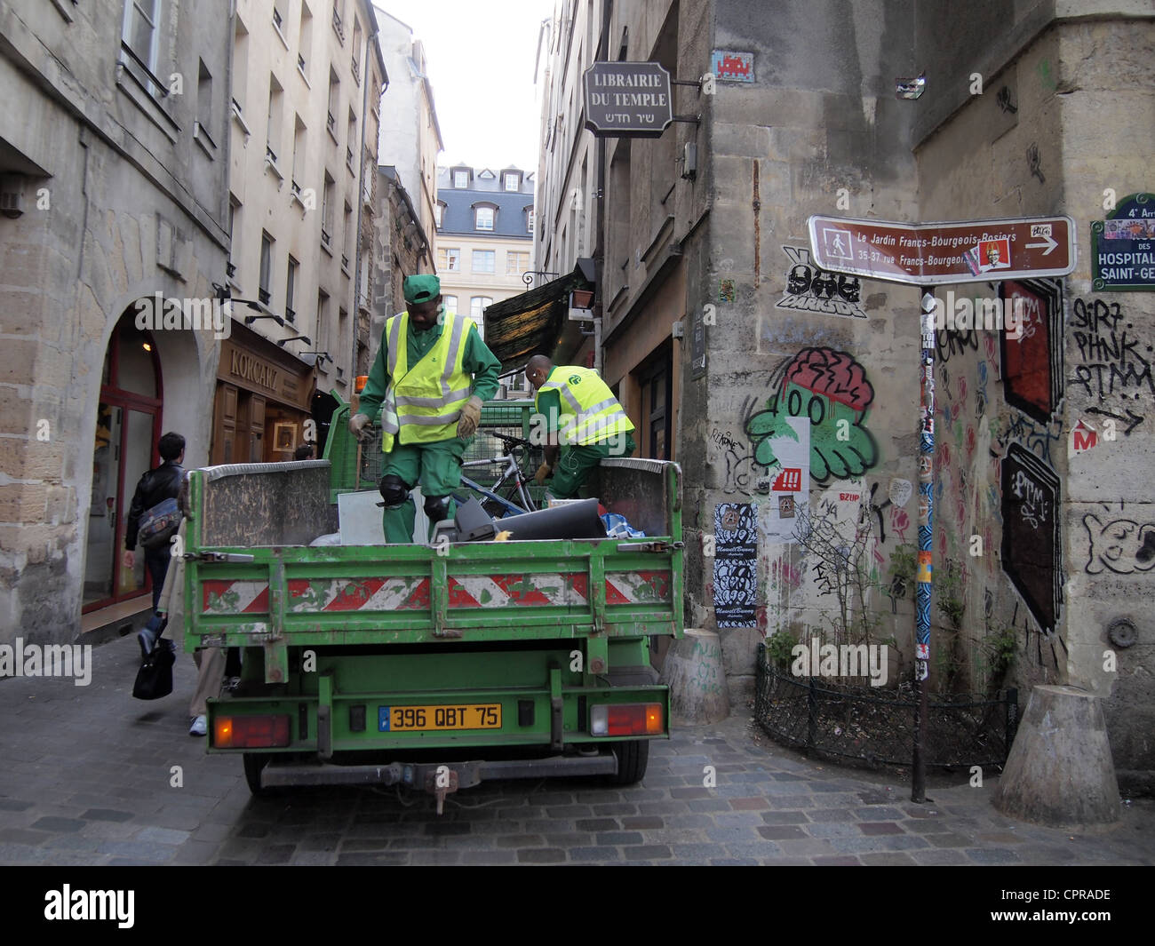Trash collectors picking up garbage on Rue des Rosiers in Paris, France ...