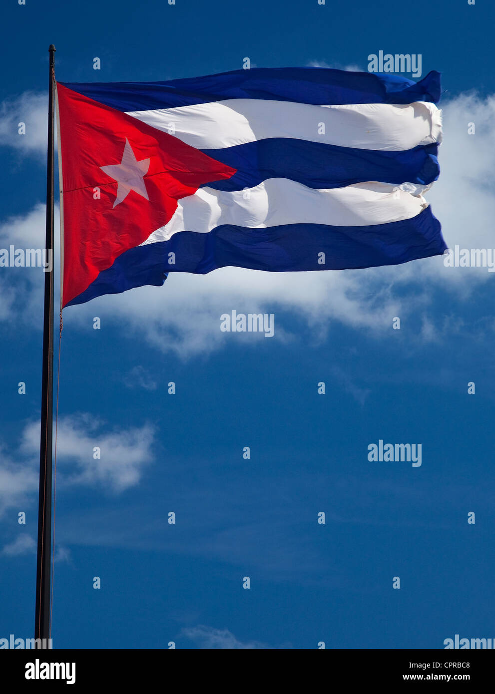 Cuban flag against blue sky and clouds Stock Photo - Alamy