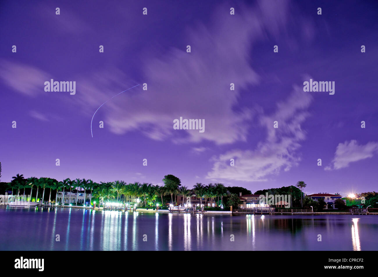 Miami with palm trees, water and blue sky at night Stock Photo - Alamy