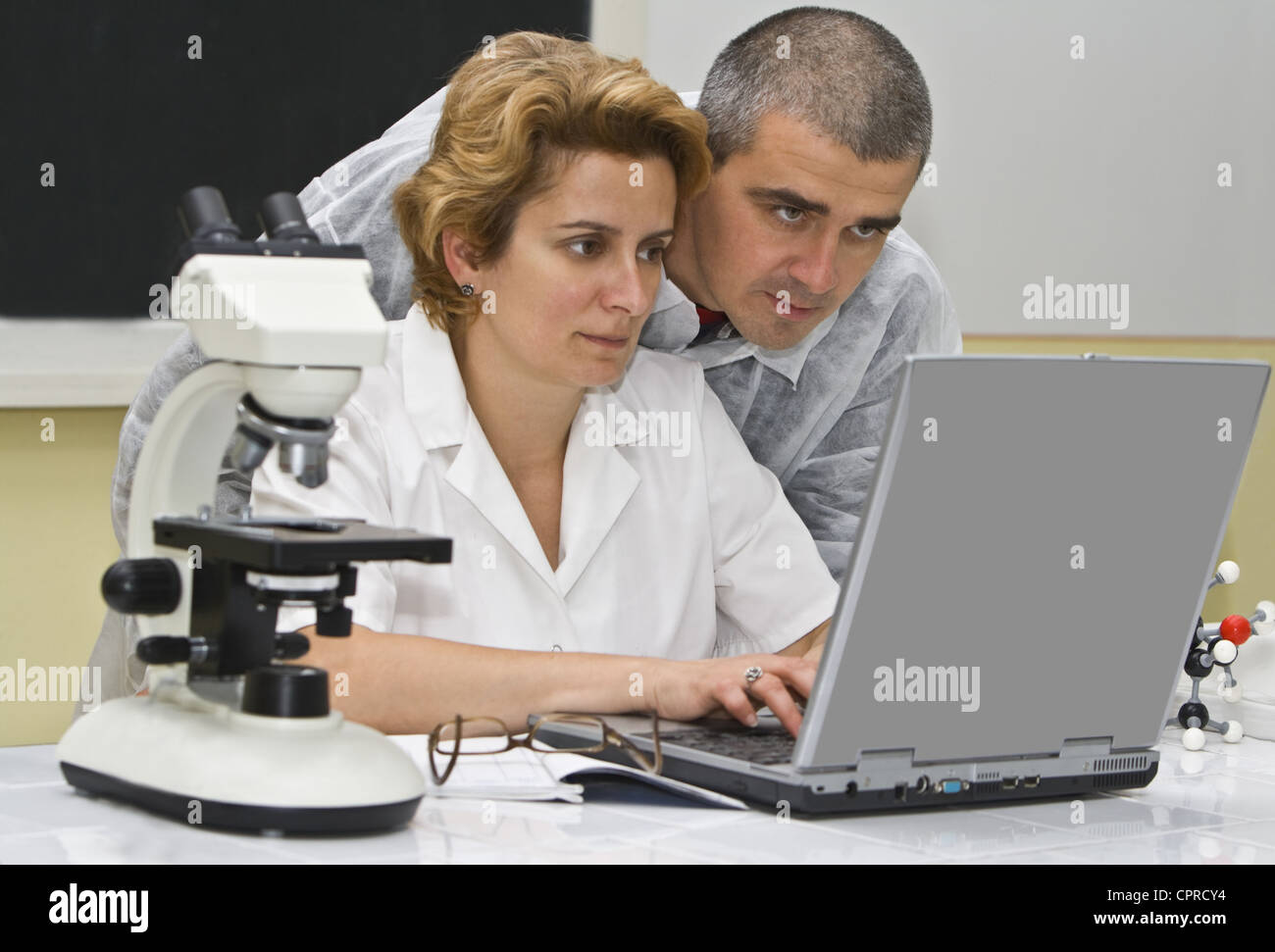 Two researchers colleagues analyzing the results of the experiment on a ...