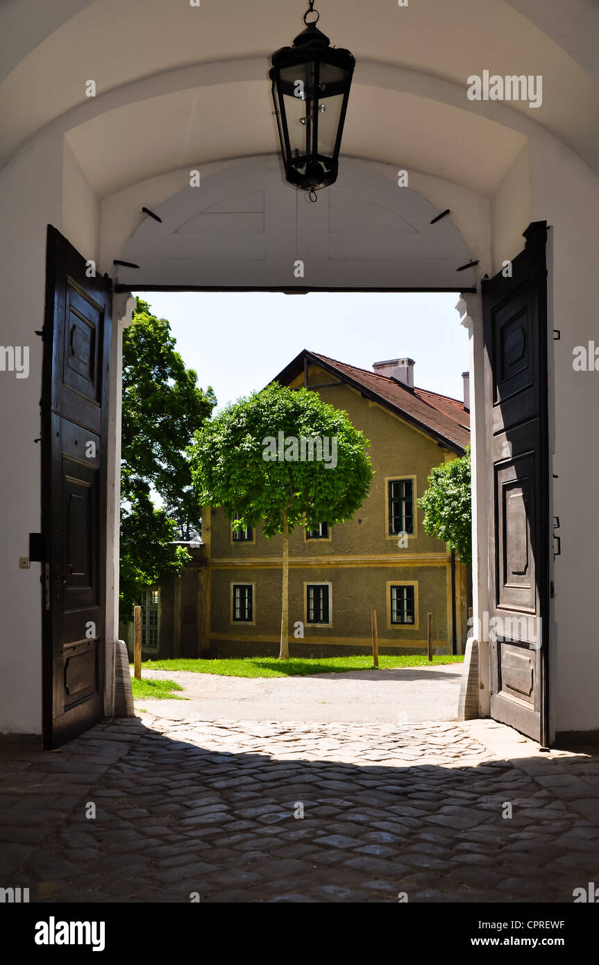 view on a old house out of a white baroque gate Stock Photo - Alamy