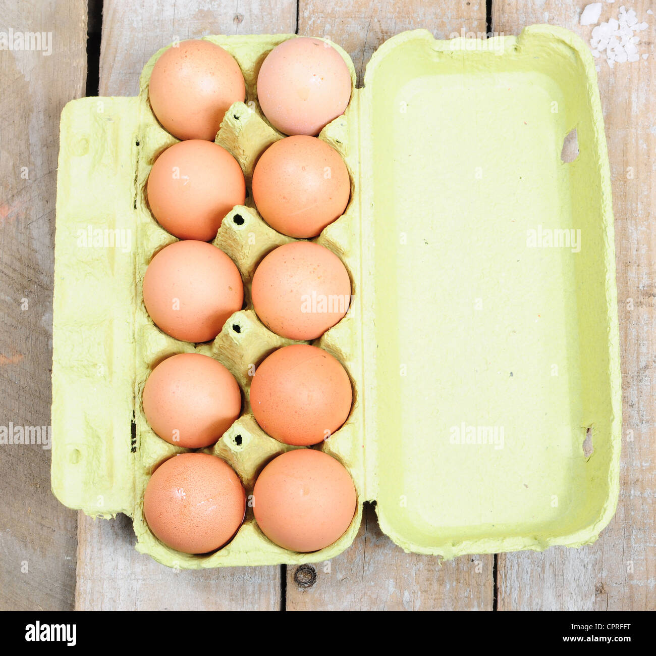 Carton of ten eggs on wooden background Stock Photo - Alamy