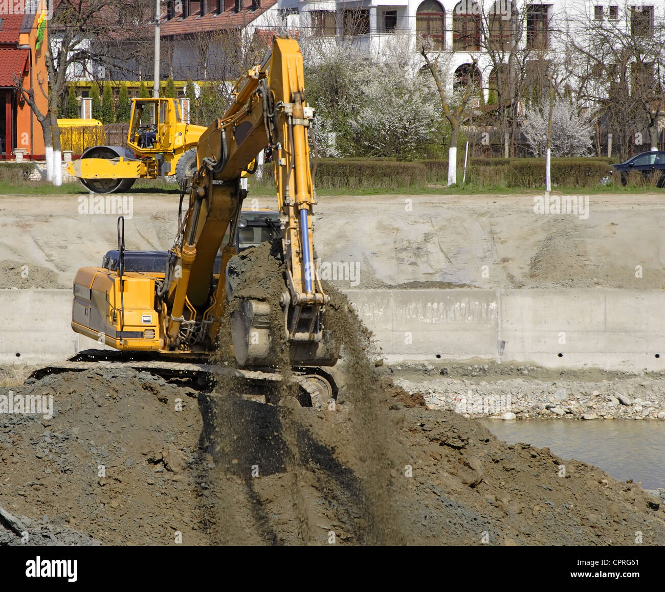 Excavator in action at the construction site Stock Photo - Alamy