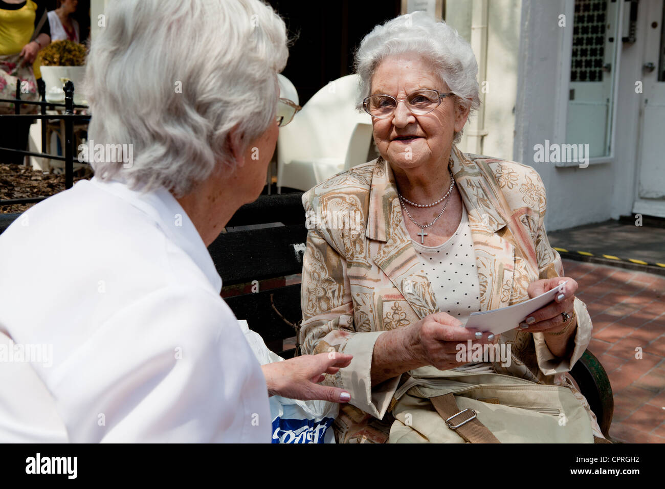 Old friends in conversation Stock Photo - Alamy