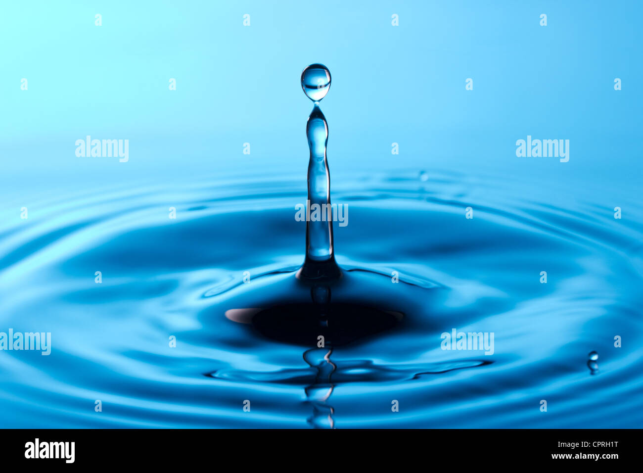 drop falling into water making a perfect droplet splash Stock Photo - Alamy