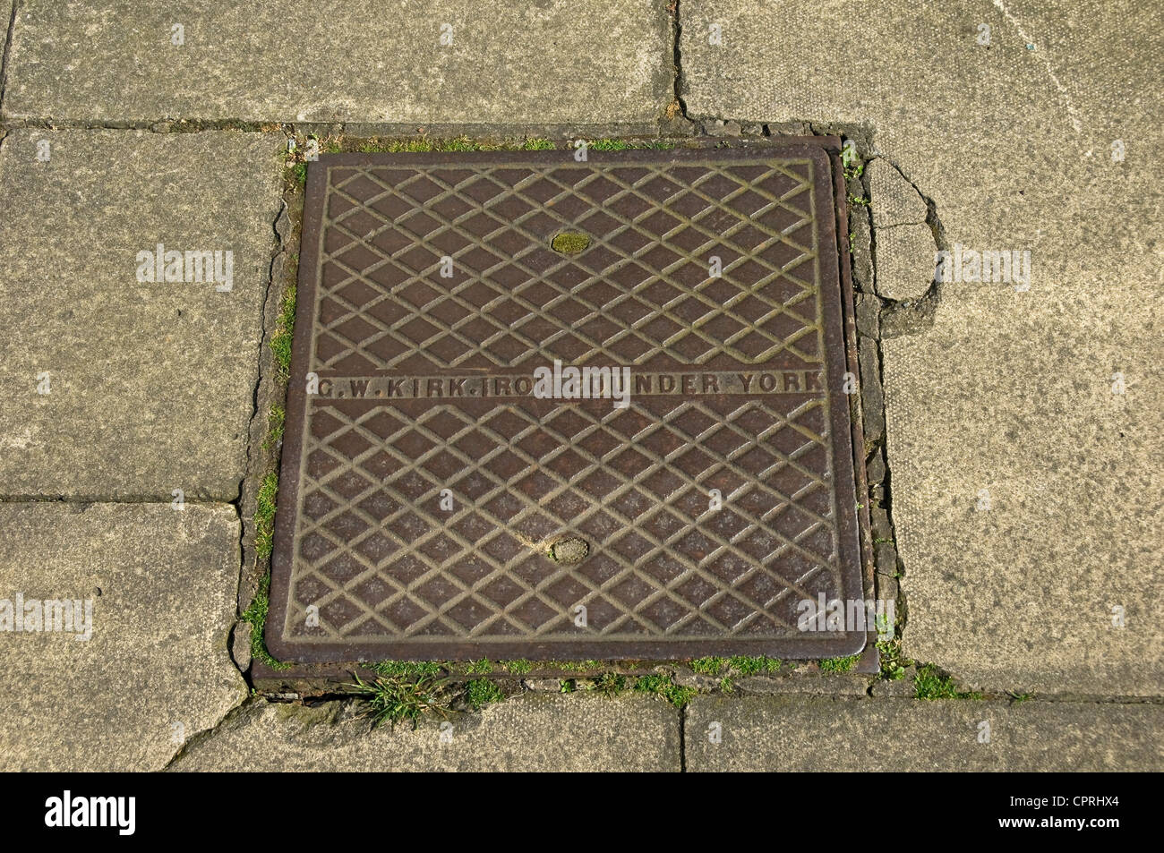 Manhole cover set in pavement England UK United Kingdom GB Great Stock ...