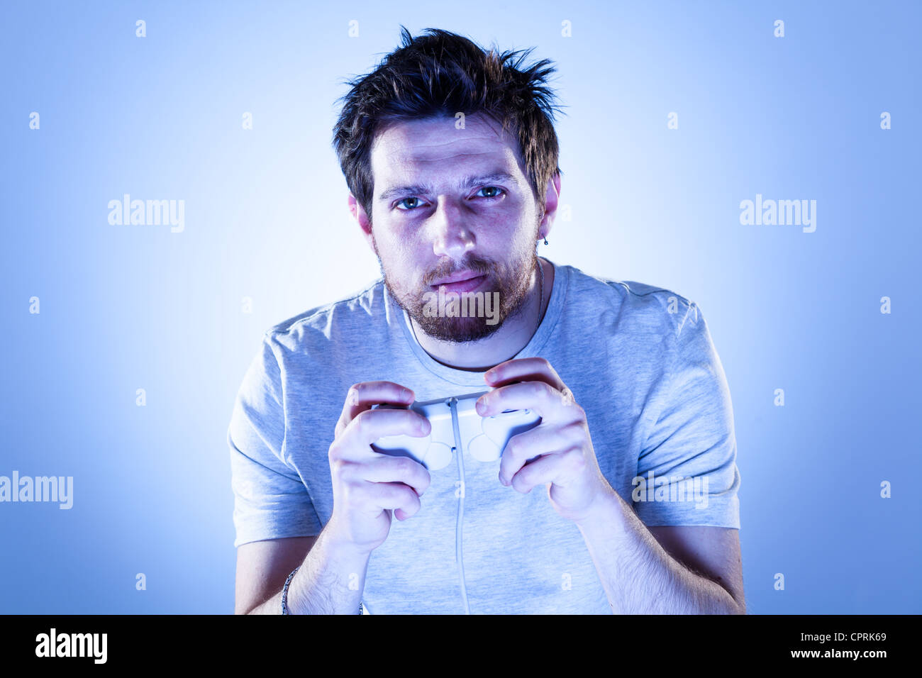 Serious Man Playing Videogames with Gamepad Stock Photo - Alamy