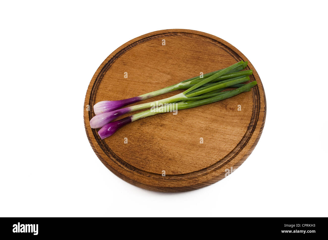 Spring onions on wooden Cut Out Stock Images & Pictures - Alamy