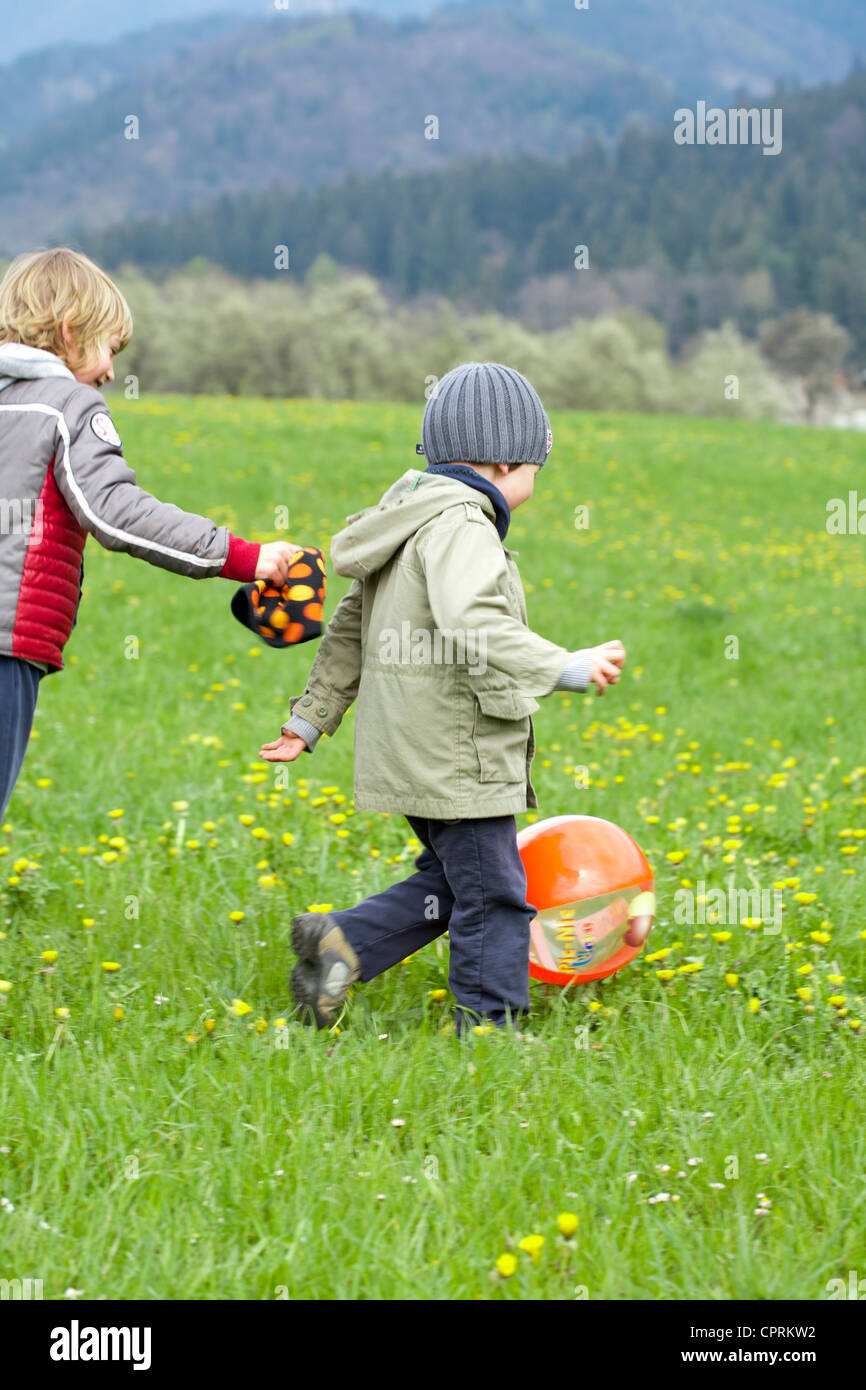 Boys chasing ball Stock Photo - Alamy