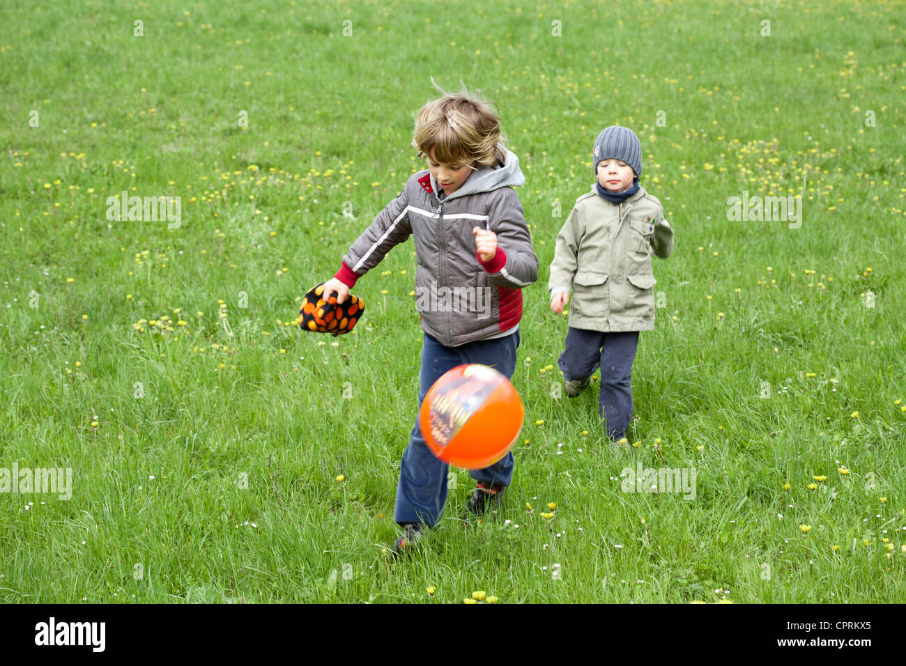 Boys chasing ball Stock Photo - Alamy